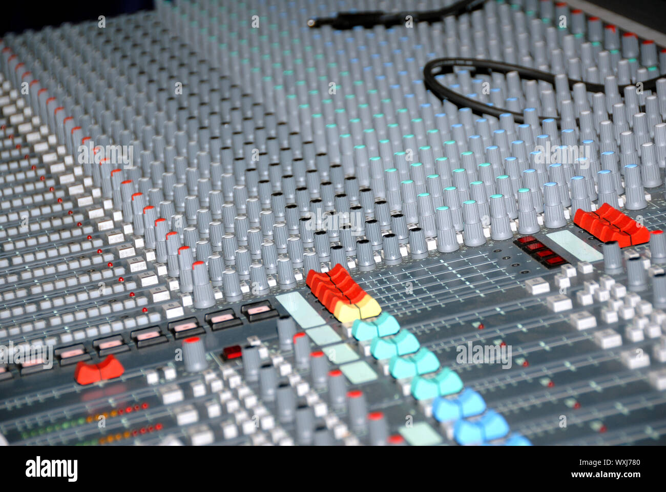 Audio mixing console in a recording studio. Faders and knobs of a sound ...