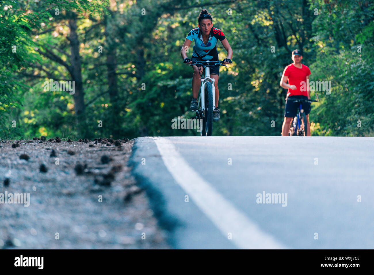 Tall handsome biker rides his bicycle on sunset in a lovely magical ...