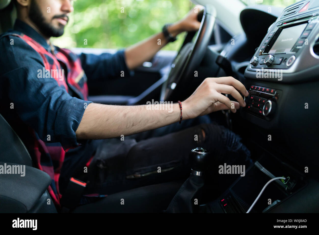 transportation and vehicle concept - man using car audio stereo system ...