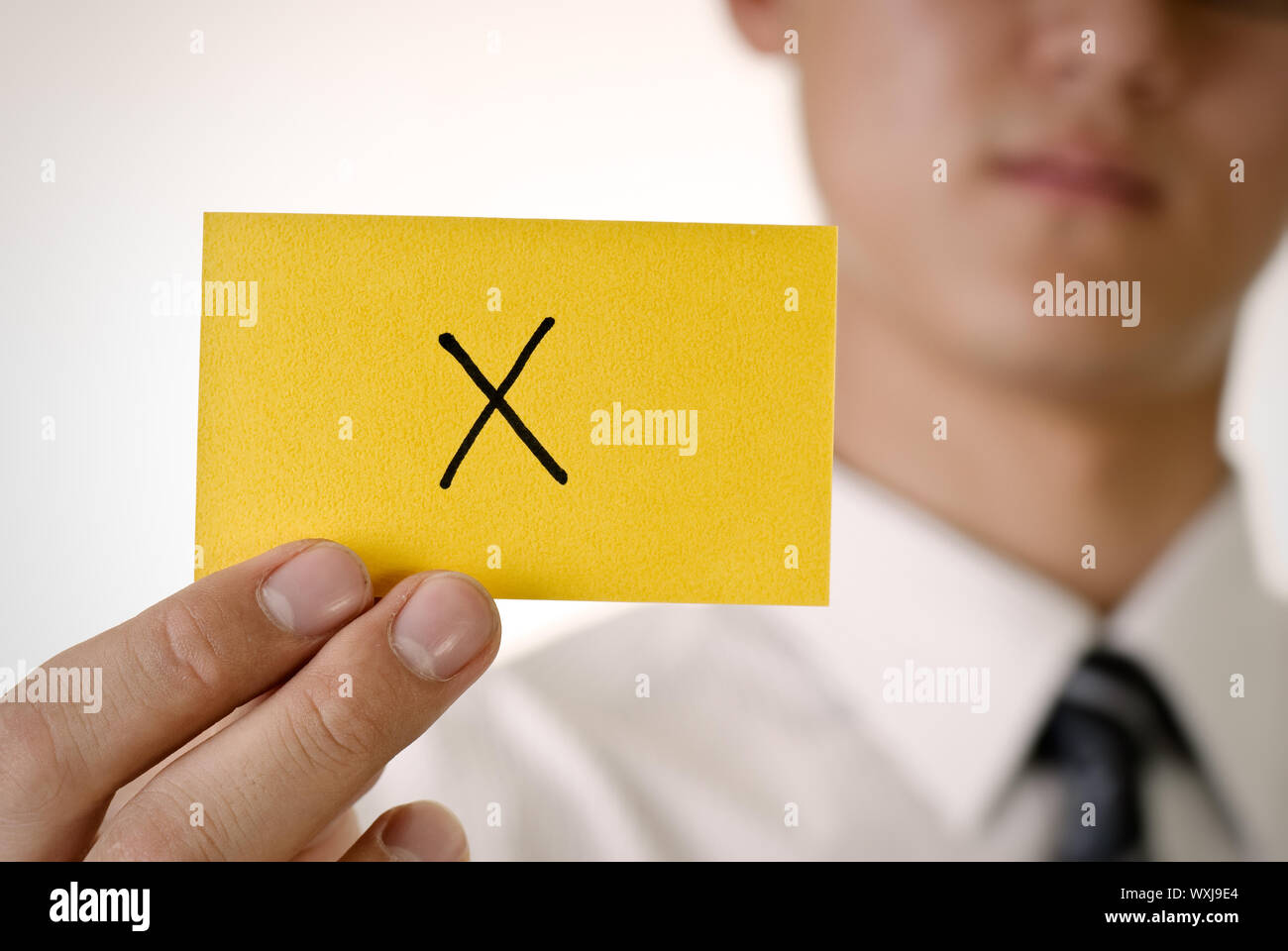 Reject pattern on yellow card hold by business man Stock Photo - Alamy