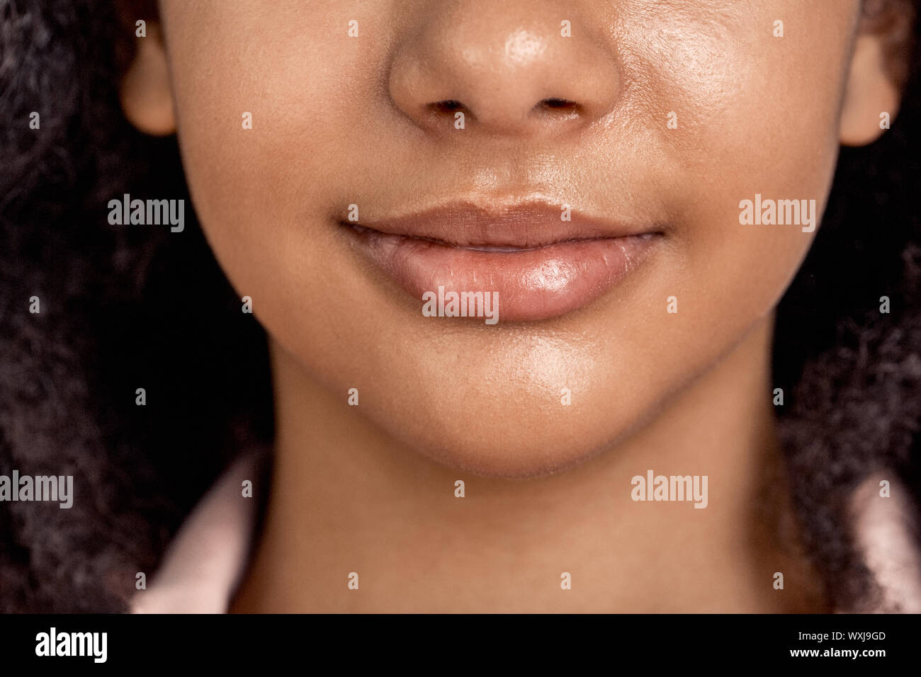 Freestyle. African girl standing isolated on pink smiling happy lips ...