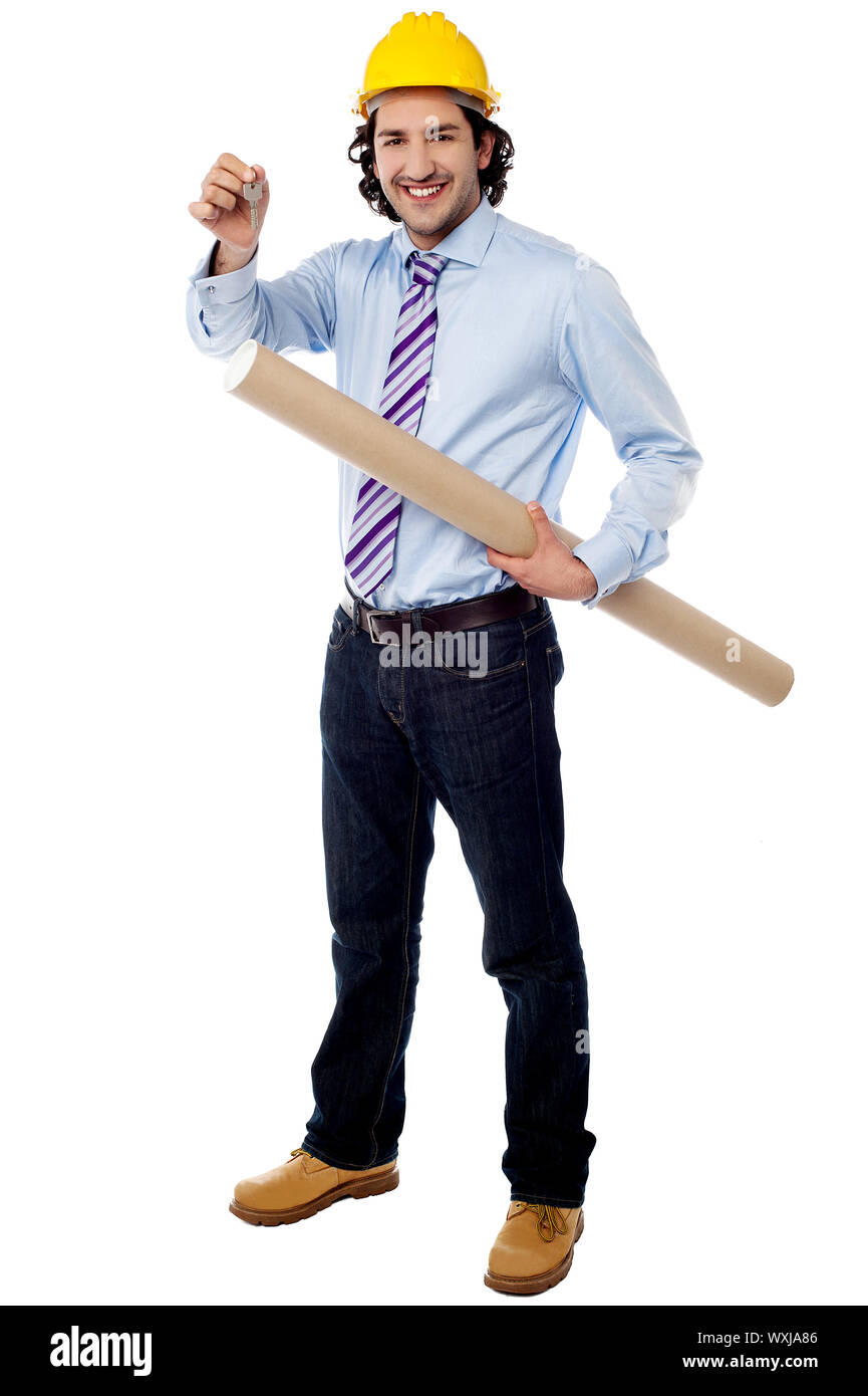 Civil engineer holding construction plan and a key Stock Photo - Alamy