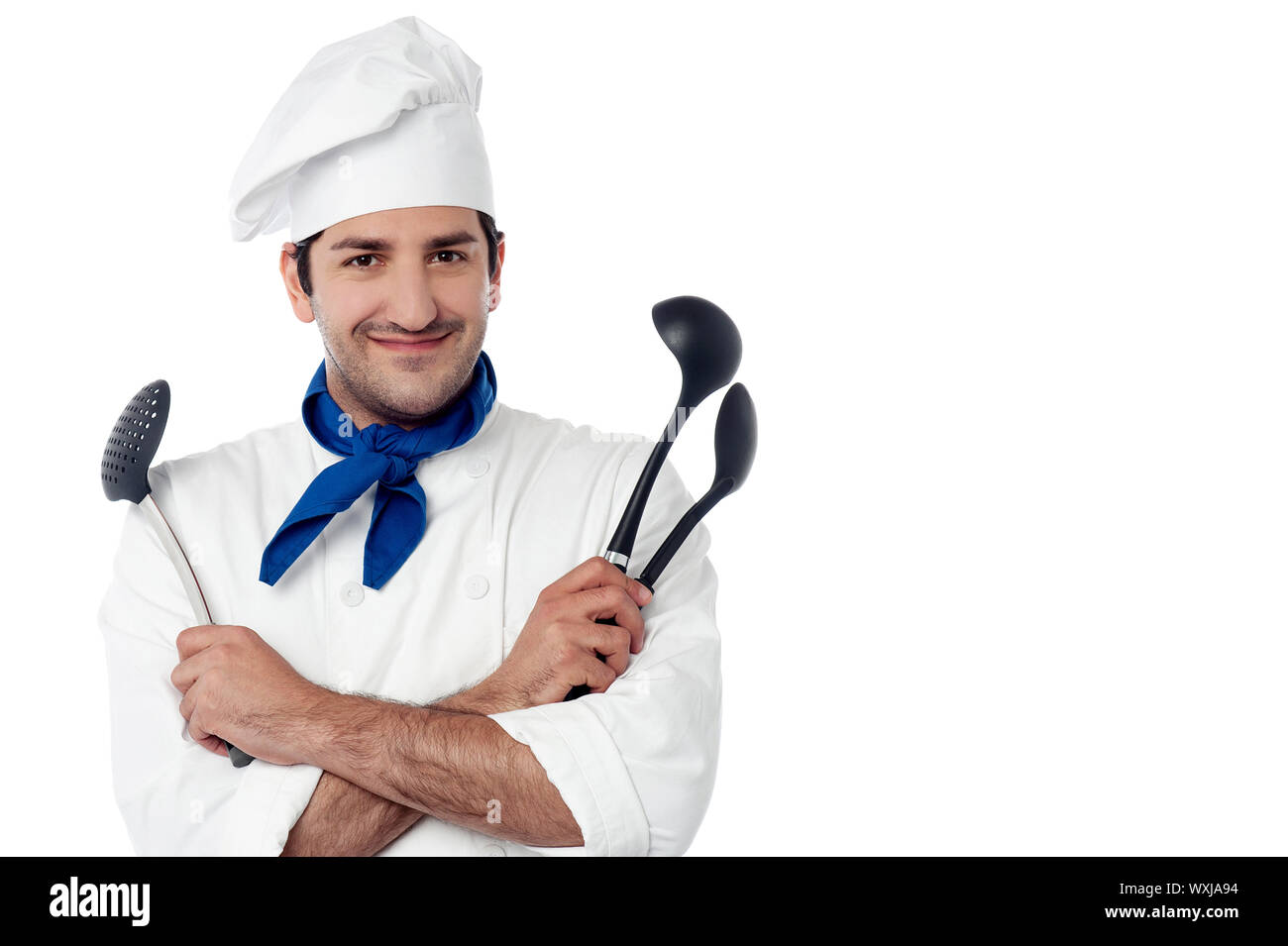 Experienced chef displaying kitchen utensils Stock Photo - Alamy