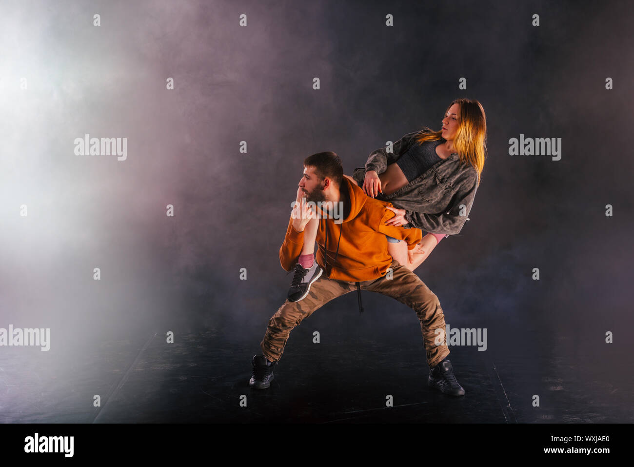 Strong male dancer and an elegant female dancer perform an exotic and ...