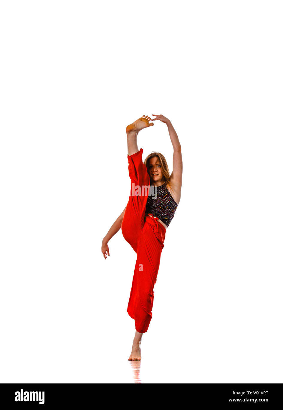 Woman in street style clothes dancing with arms spread and raised up ...