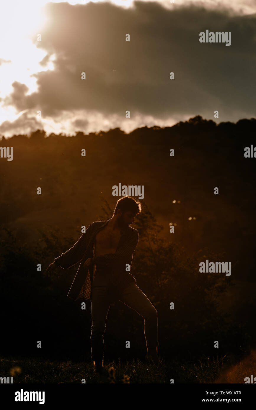 Handsome man dancer while dancing to the rhythm of the dance on ...