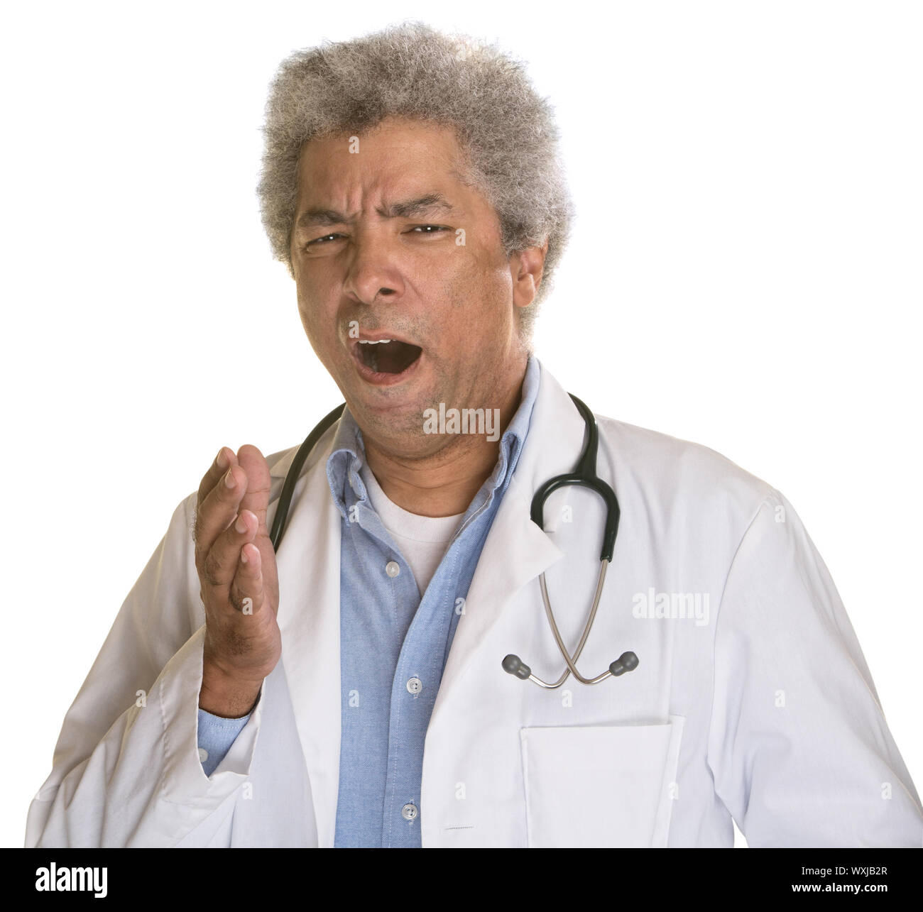 Sleepy medical doctor yawning over white background Stock Photo - Alamy
