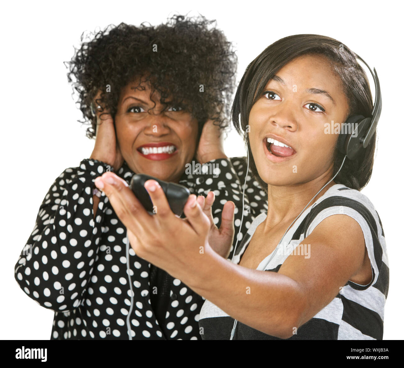 Woman covering her ears while young person sings Stock Photo - Alamy