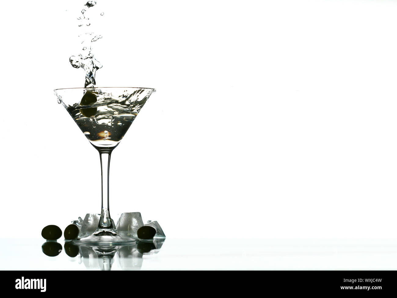 martini glass splash bar background Stock Photo - Alamy