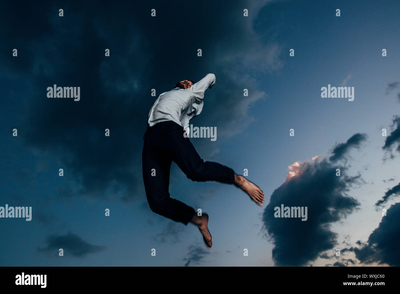 Profile view of a male urban dancer practicing some dance moves and ...