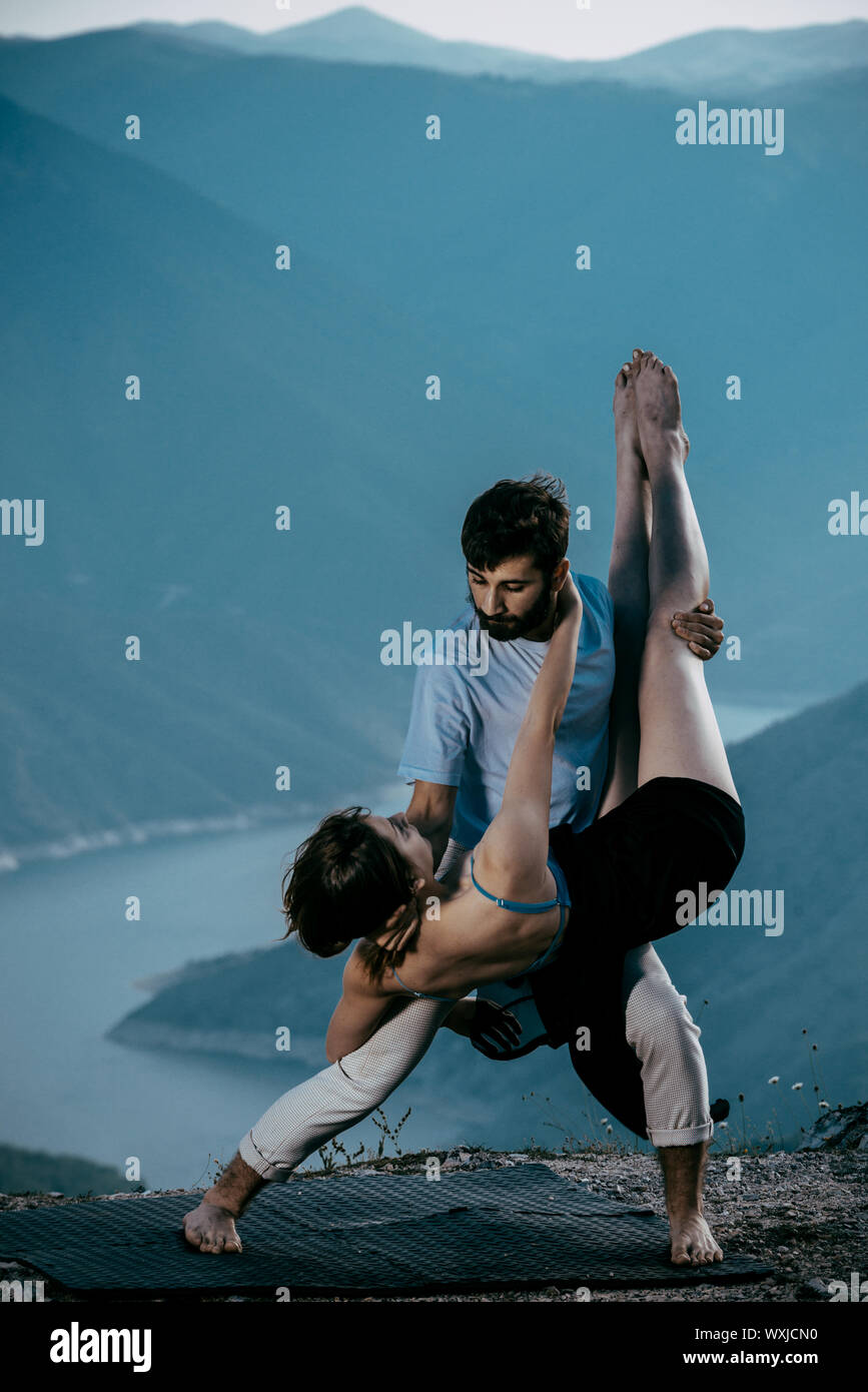 Romantic young loving couple dancing outdoors under blue sky at ...