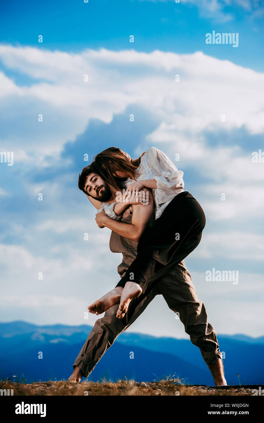 Young beautiful barefoot couple dancer practicing modern dance at ...
