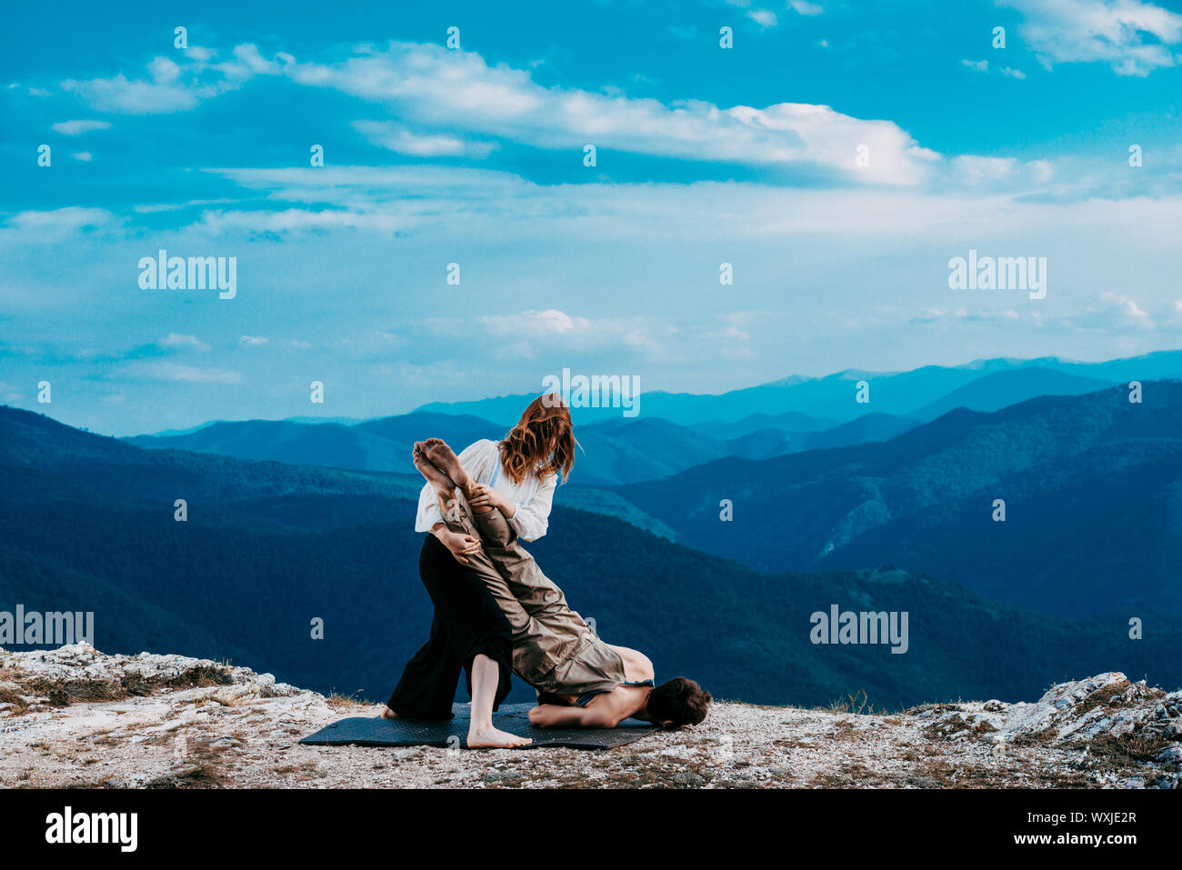 Young beautiful barefoot couple dancer practicing modern dance at ...