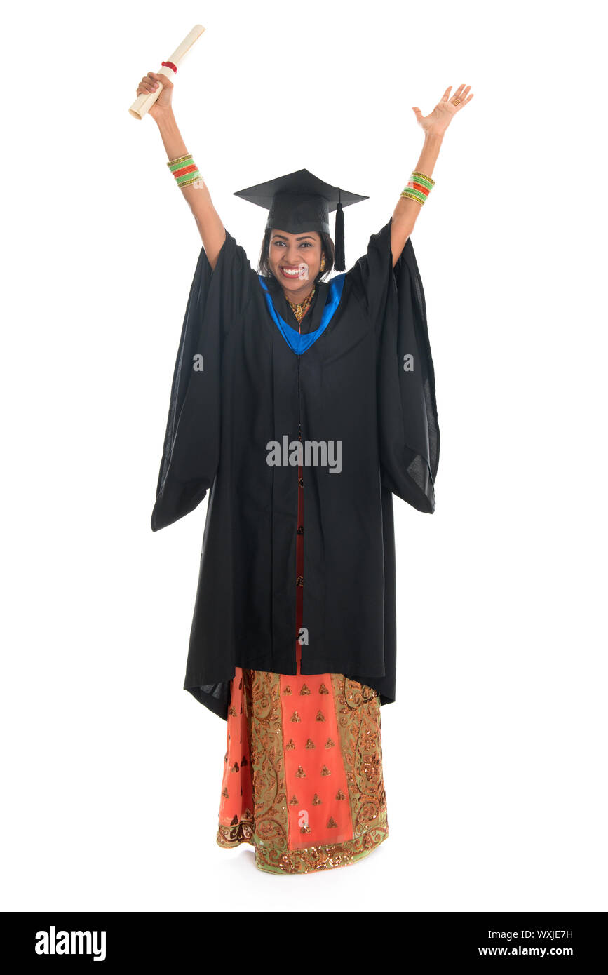 Full length arms up Indian university student in graduation gown and ...