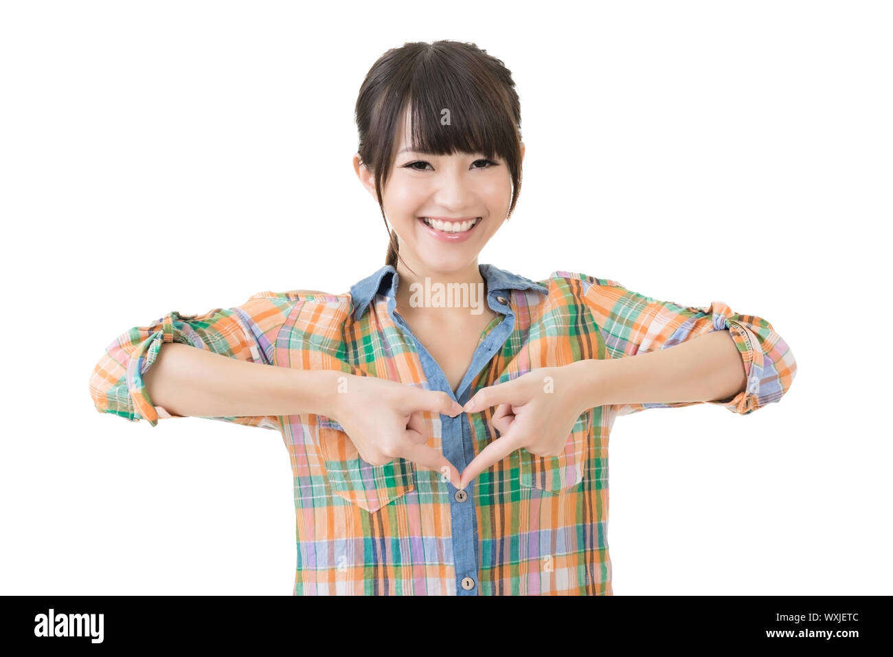 Smiling asian woman make heart shape with hands. Isolated on the white ...
