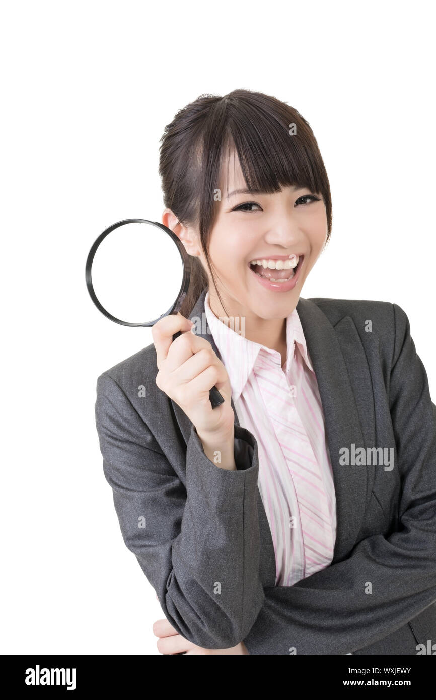 Portrait of a beautiful young asian businesswoman holding magnifying ...