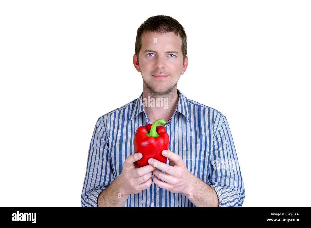 Man holding a big red bell pepper Stock Photo - Alamy