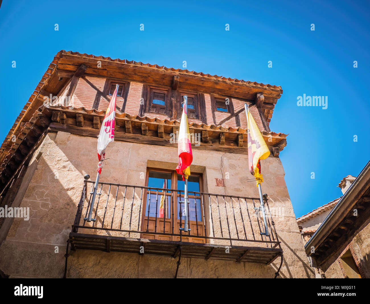 A Spanish flag in the medieval town of Pedraza, which is located in ...
