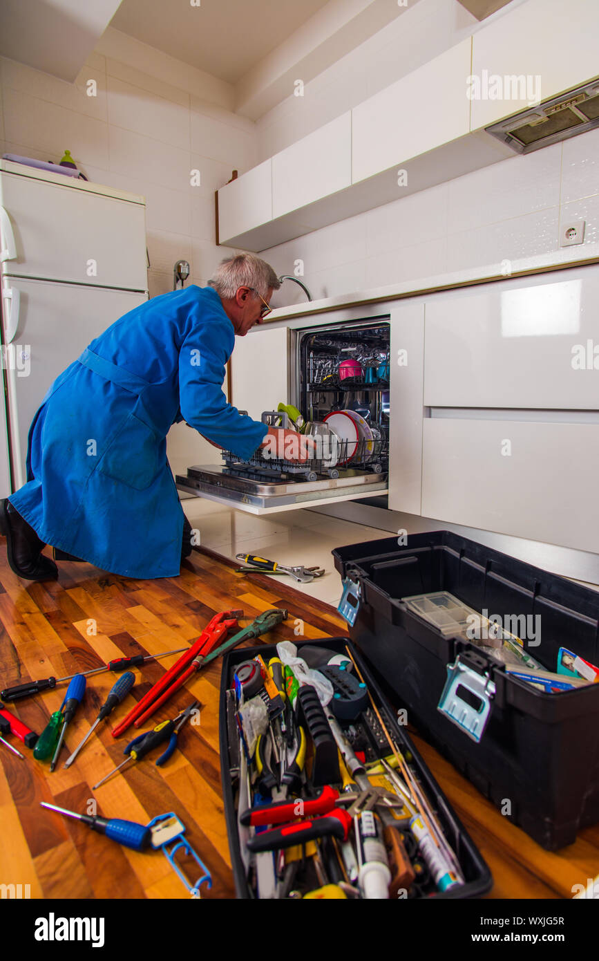 Senior handyman standing next to his tool box Stock Photo - Alamy