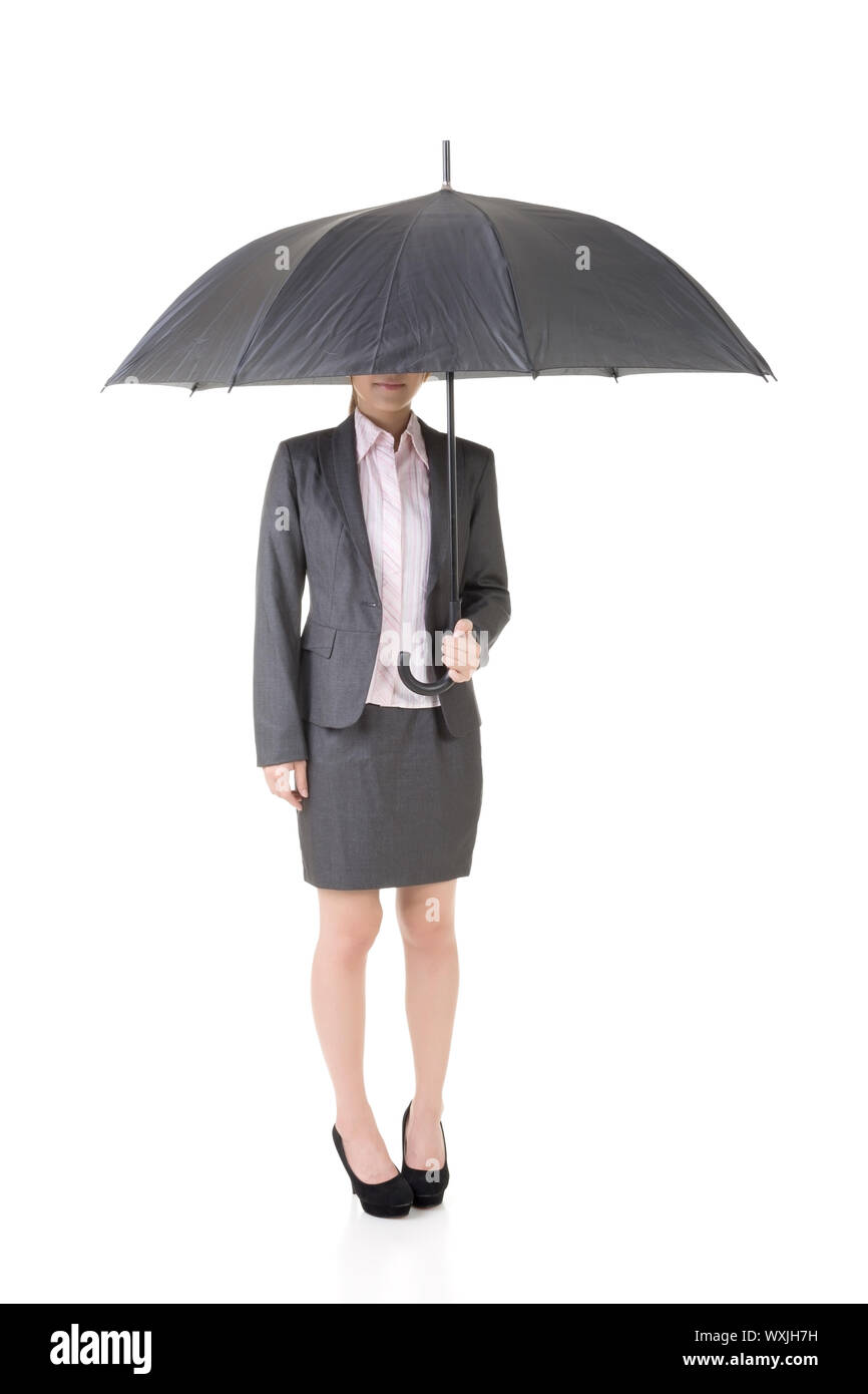 Asian business woman is holding umbrella with half hidden face under it ...