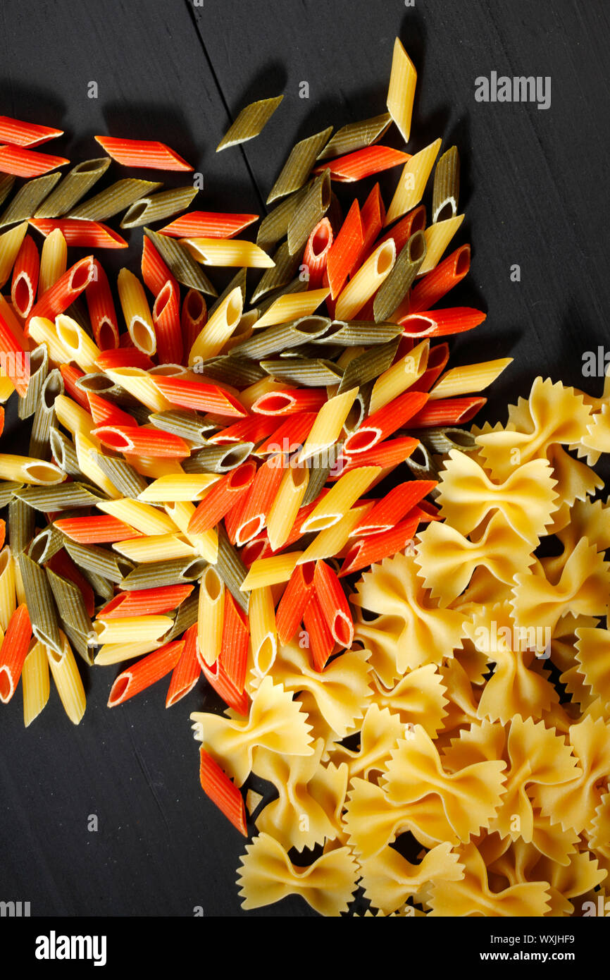Variety of types and shapes of Italian pasta on black table Stock Photo ...