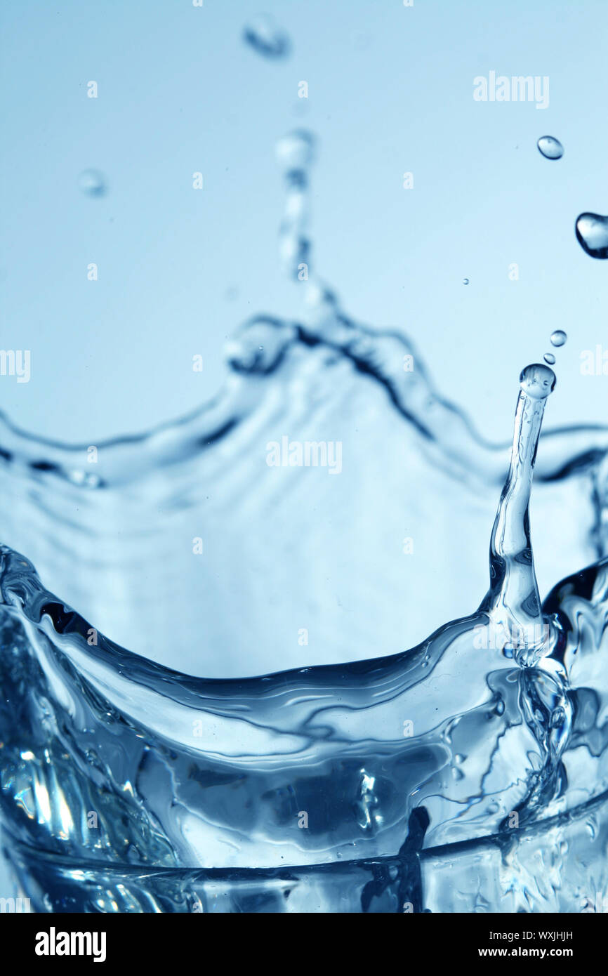 super splash in glass on white background Stock Photo - Alamy