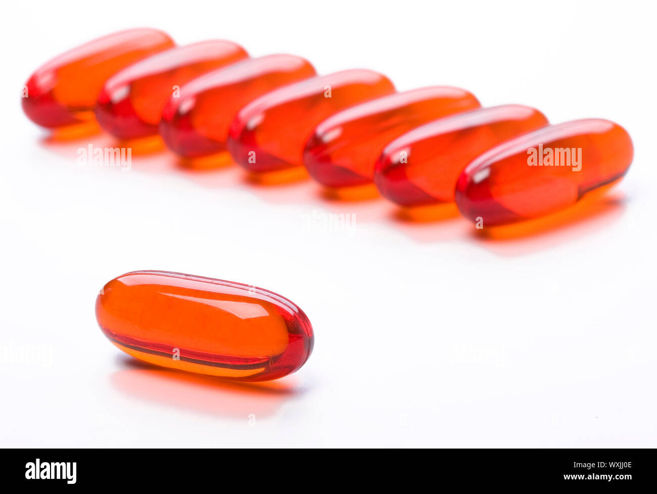 red tablets isolated on white background Stock Photo - Alamy