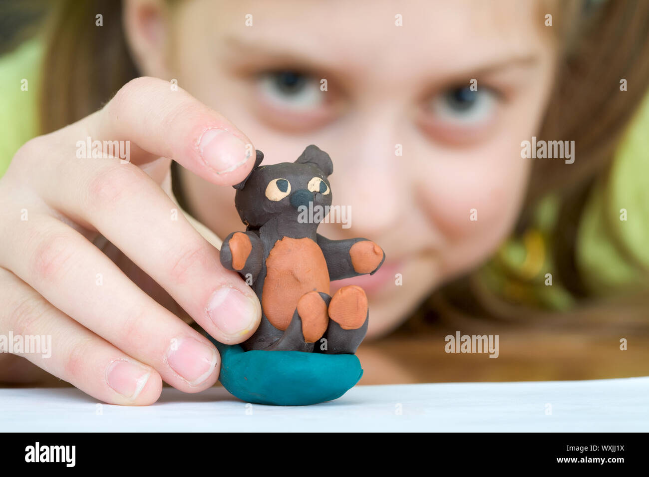 Bear stuck together from plasticine and girl Stock Photo - Alamy