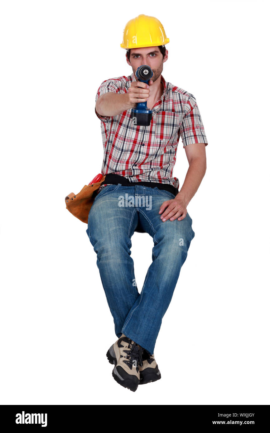 Laborer holding a drill Stock Photo - Alamy