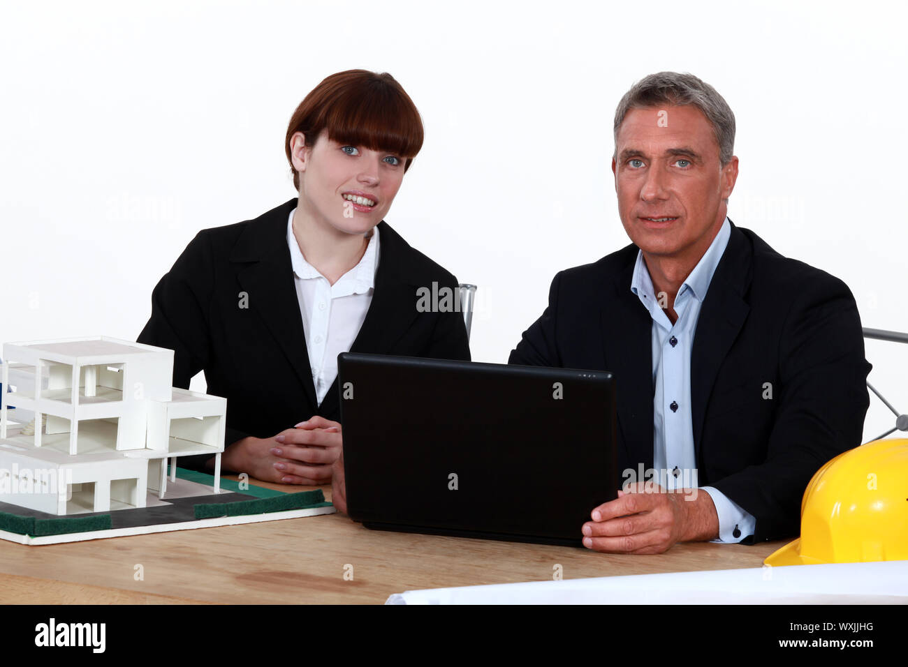 Architect at desk with assistant Stock Photo - Alamy