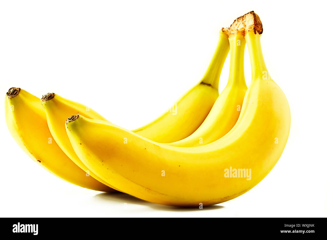 three yellow bananas on white background Stock Photo - Alamy