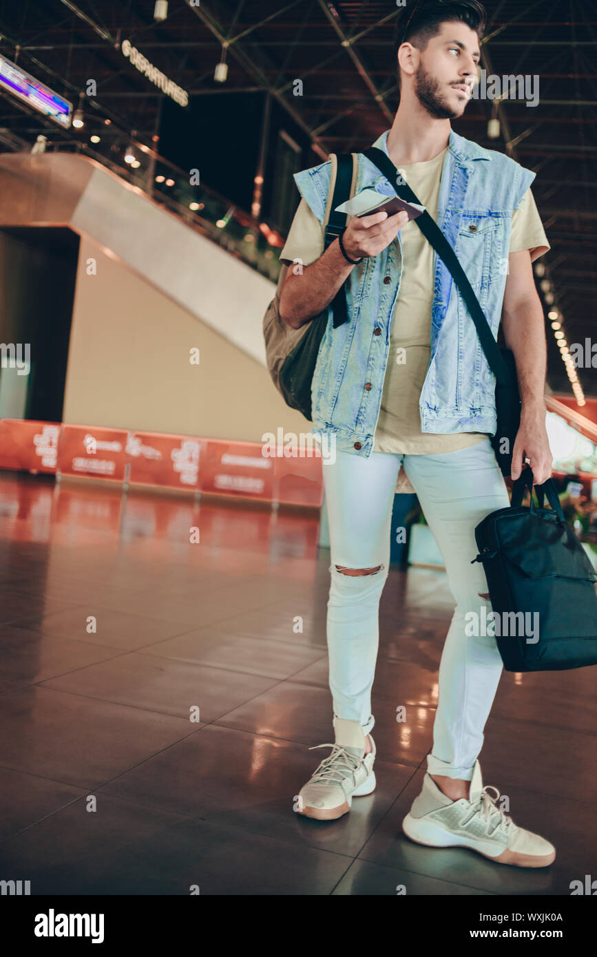 Tranquil man is standing in lobby and waiting for his plane Stock Photo ...
