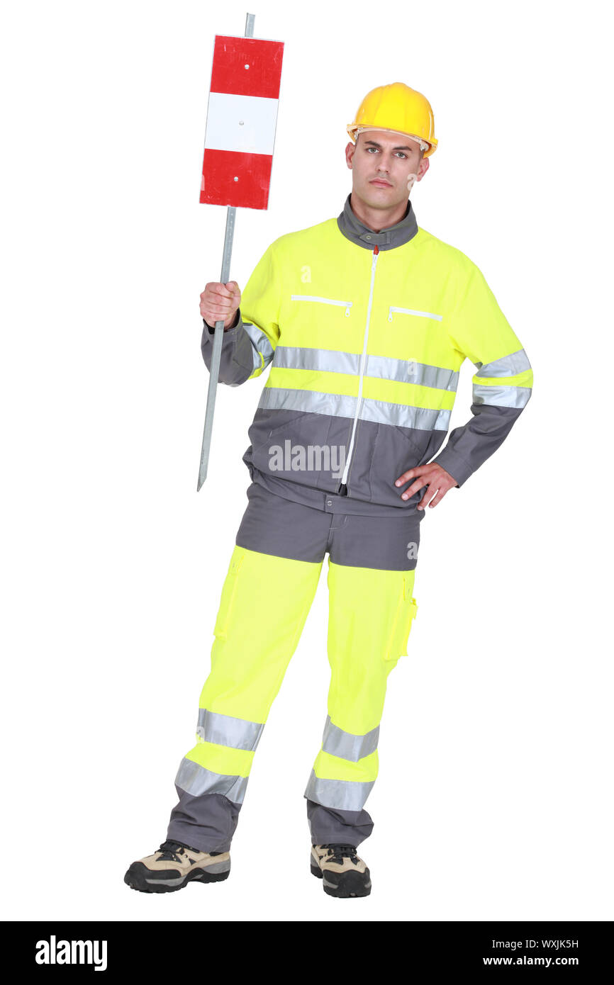 construction worker in safety outfit holding construction sign Stock ...