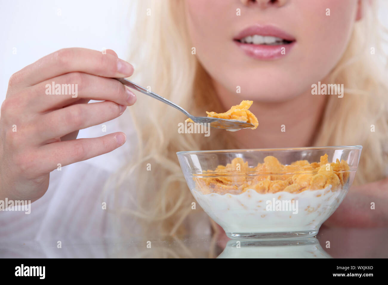 Woman eating cereal Stock Photo - Alamy