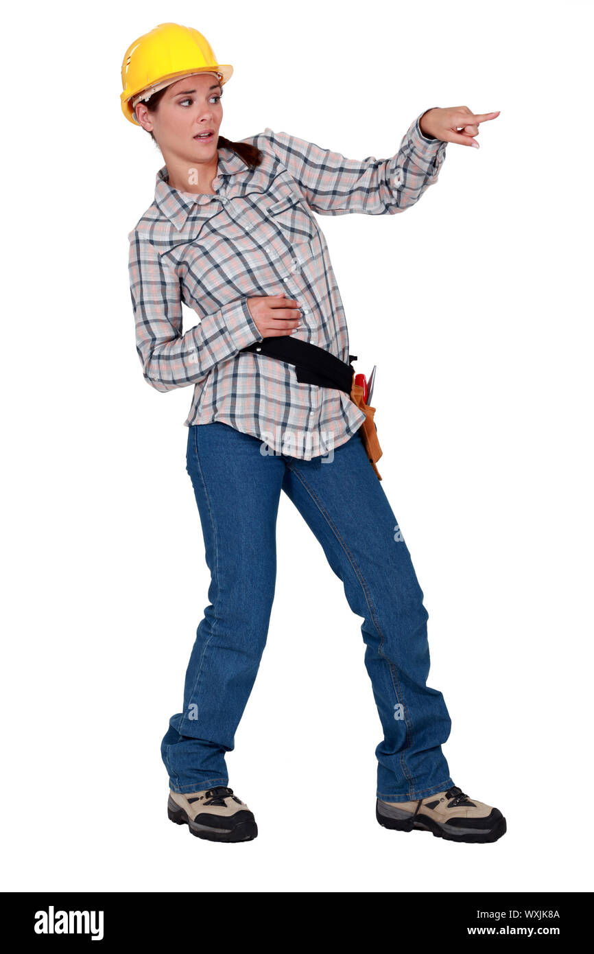 A disgusted female construction worker pointing at something Stock ...