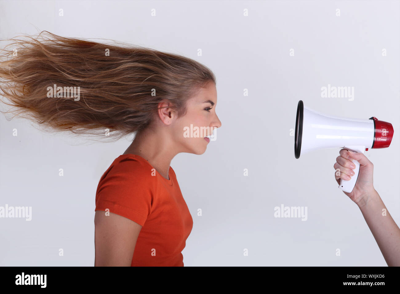 Woman facing megaphone Stock Photo - Alamy