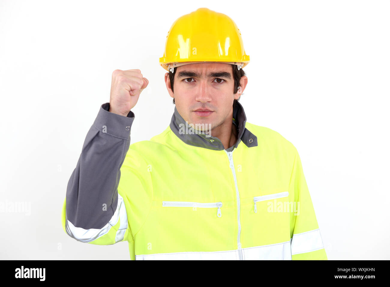 Angry builder waving fist Stock Photo - Alamy