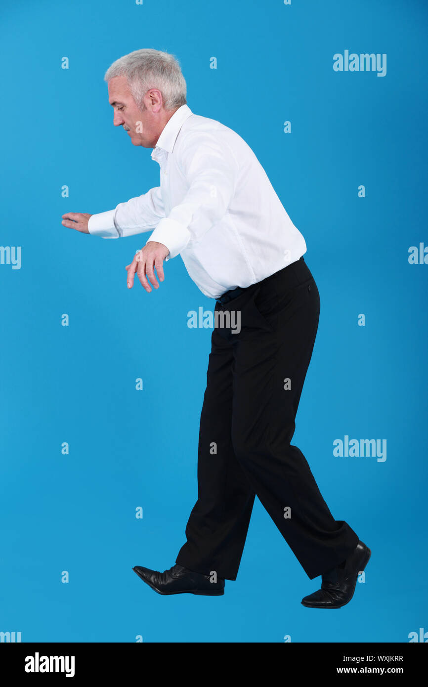 Businessman walking on tight-rope Stock Photo - Alamy