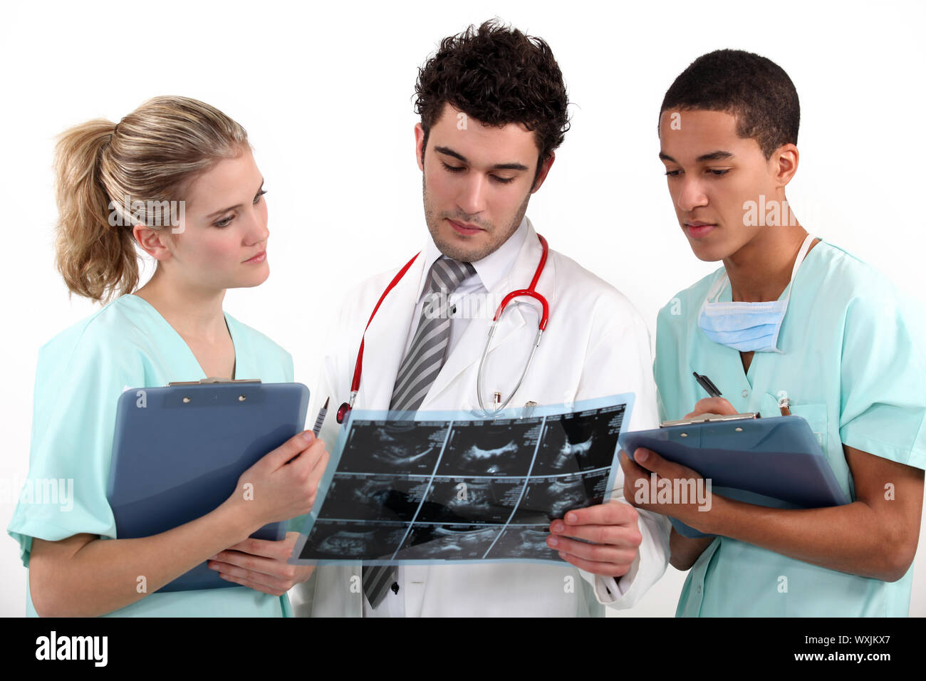 A doctor and his assistants checking a radiography Stock Photo - Alamy