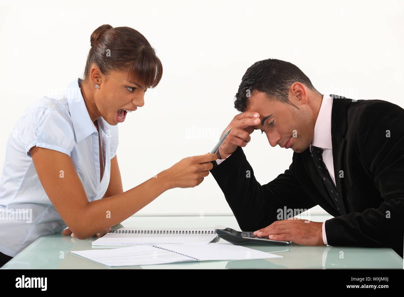 Woman shouting at a man across a desk Stock Photo - Alamy