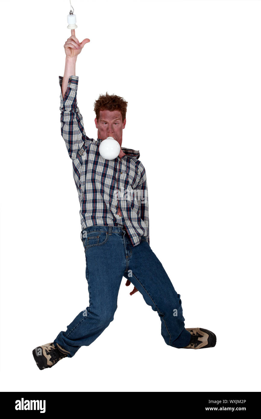 Man putting finger in electrical socket Stock Photo - Alamy