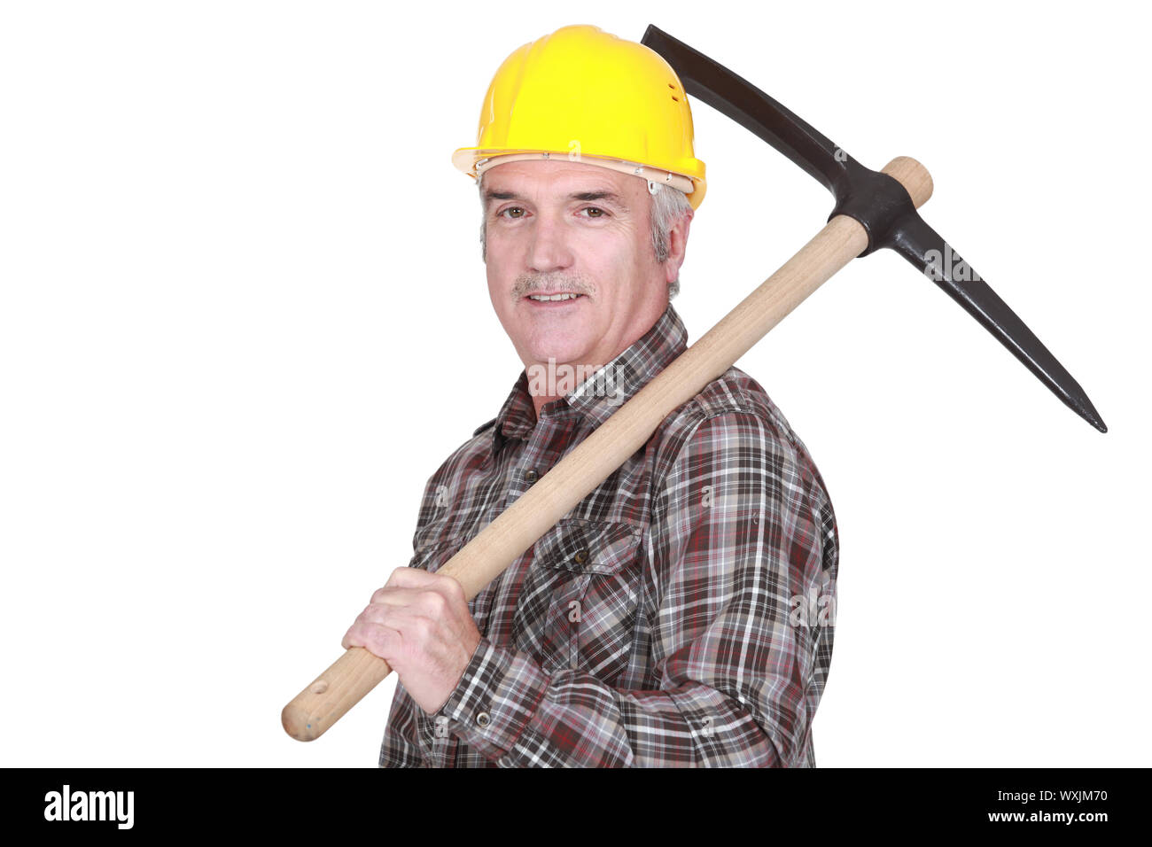 Mature laborer carrying a pickaxe on his shoulder Stock Photo - Alamy