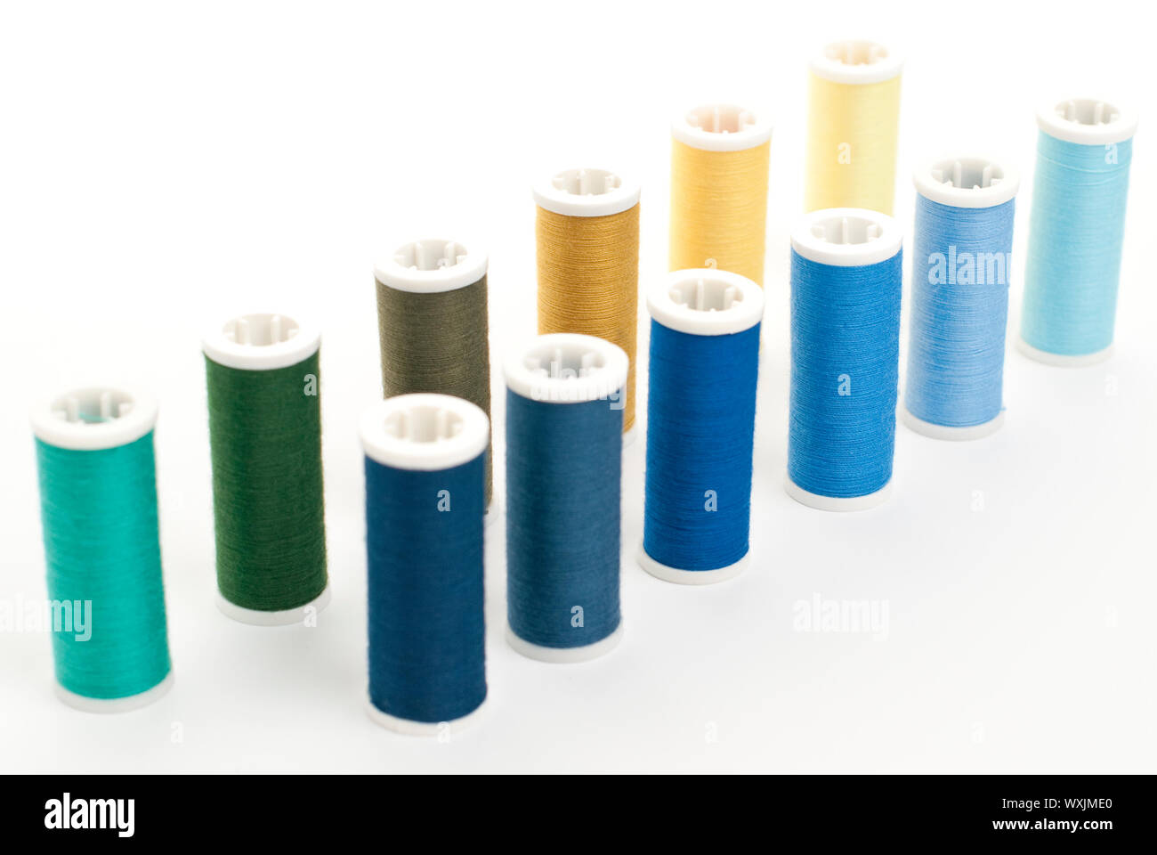 Colorful Spools of sewing thread isolated on white background Stock ...
