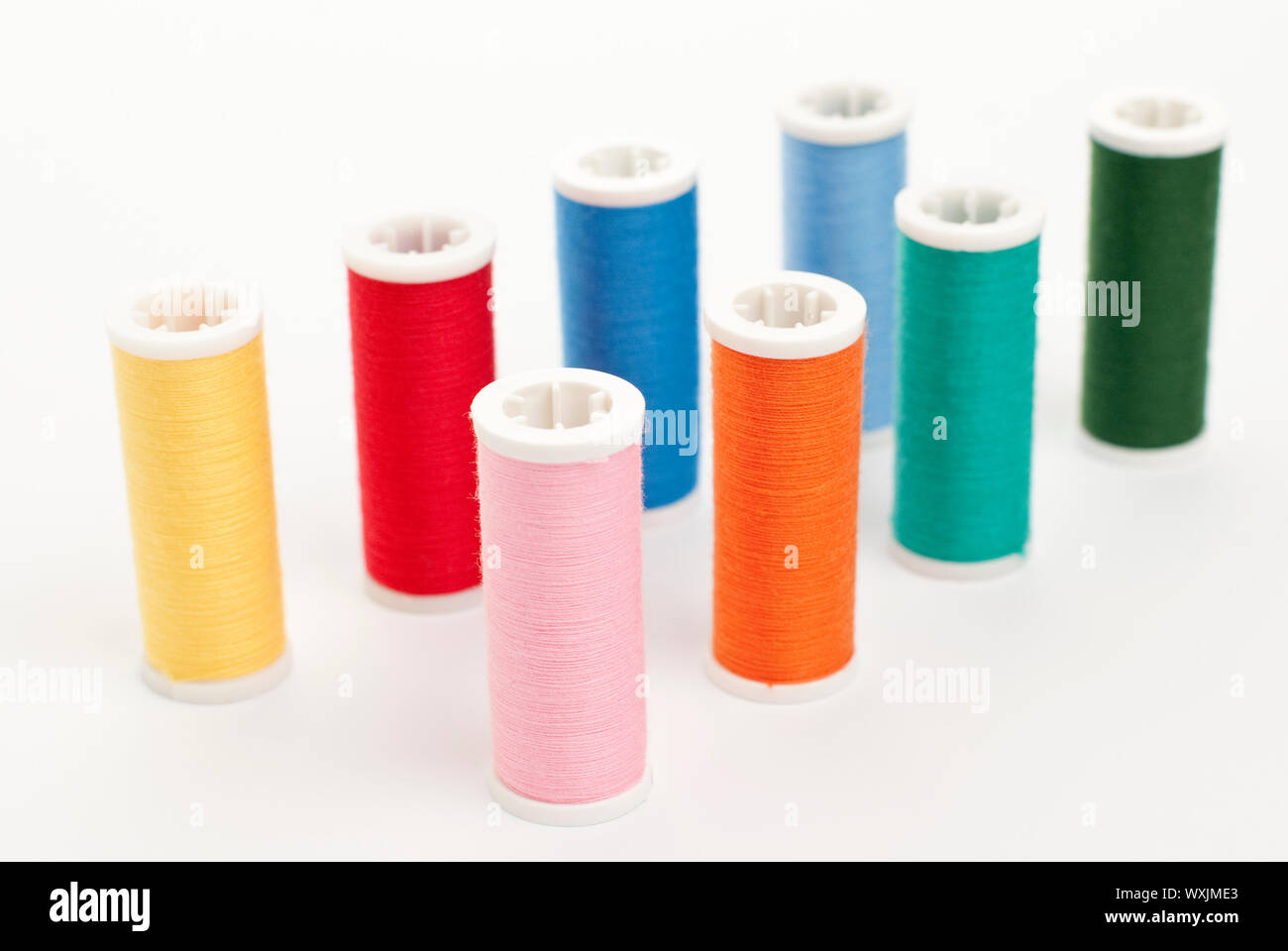 Colorful Spools of sewing thread isolated on white background Stock ...