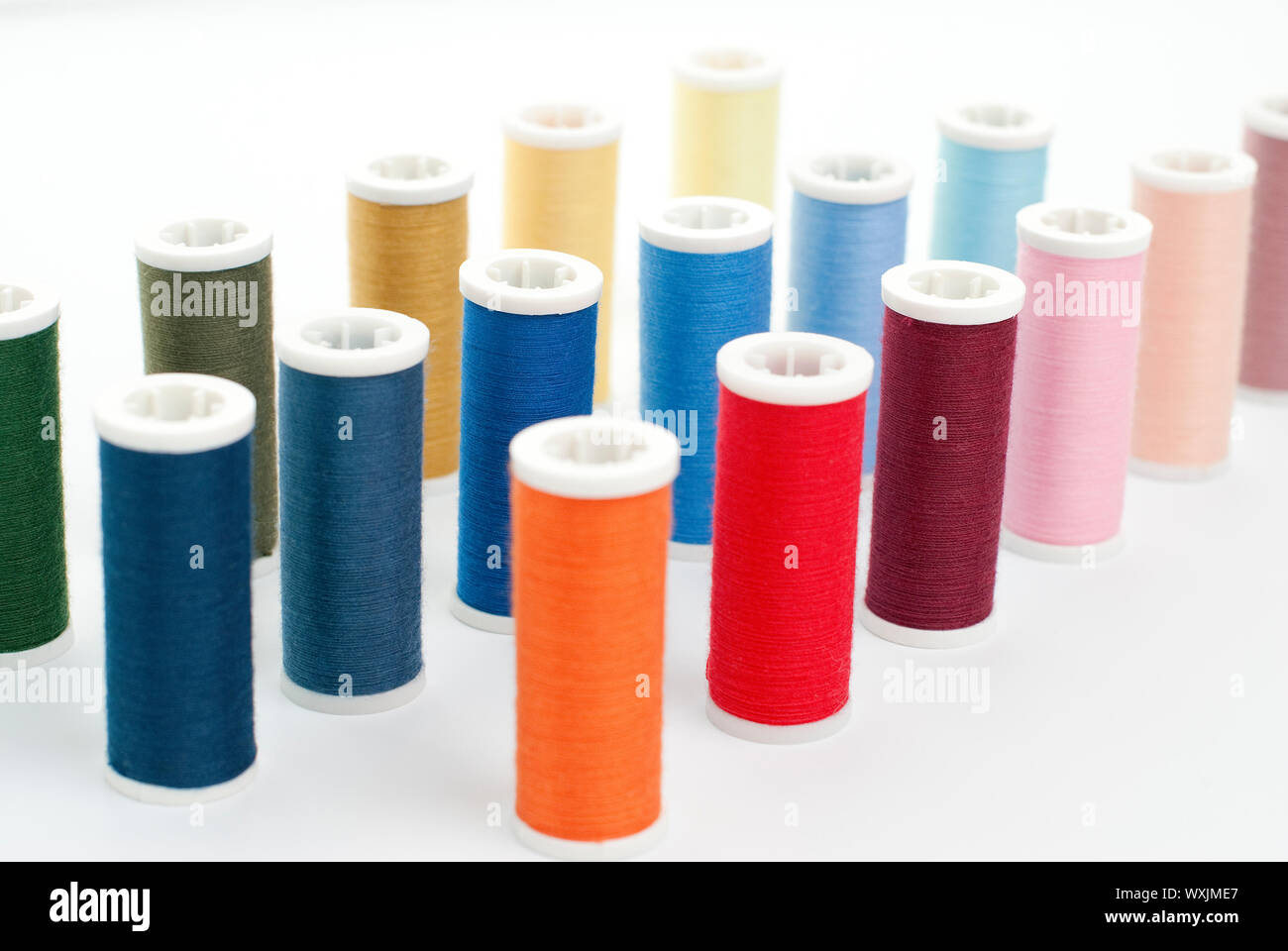 Colorful Spools of sewing thread isolated on white background Stock ...