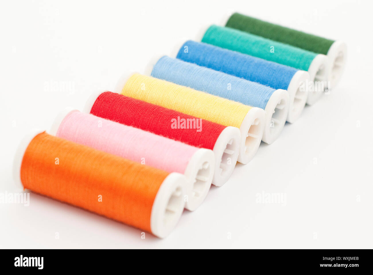Colorful Spools of sewing thread isolated on white background Stock ...