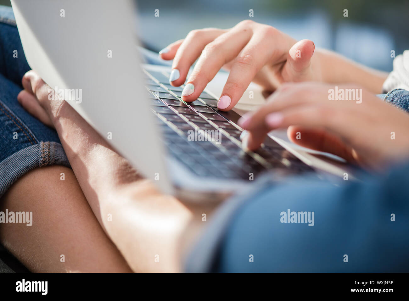 Typing hands of a schoolgirl and laptop close-up Stock Photo - Alamy