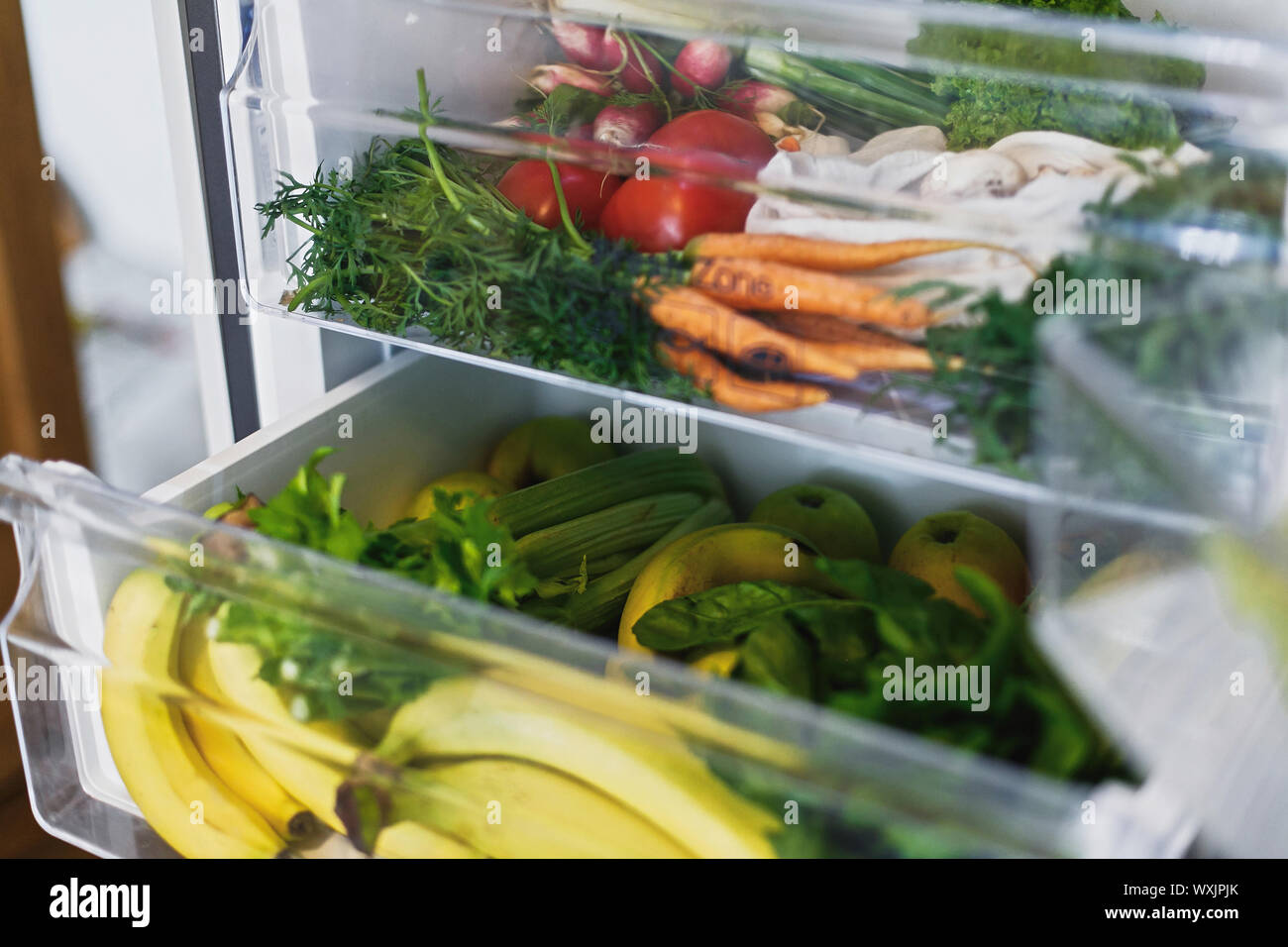 Zero waste grocery in fridge. Fresh vegetables in opened drawer in ...