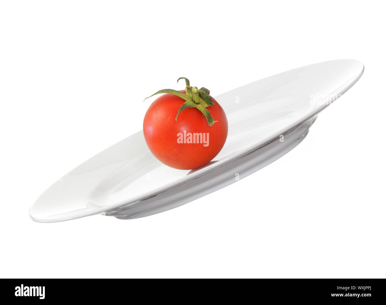 Tomato on plate isolated on white background Stock Photo - Alamy