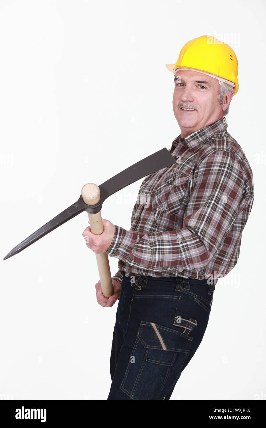Man holding pick-axe Stock Photo - Alamy